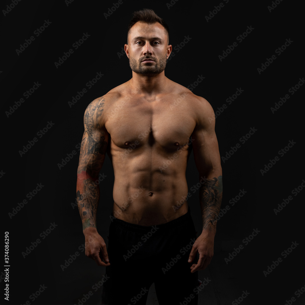 Handsome bodybuilder man with an ideal body, after coaching abdominal ...