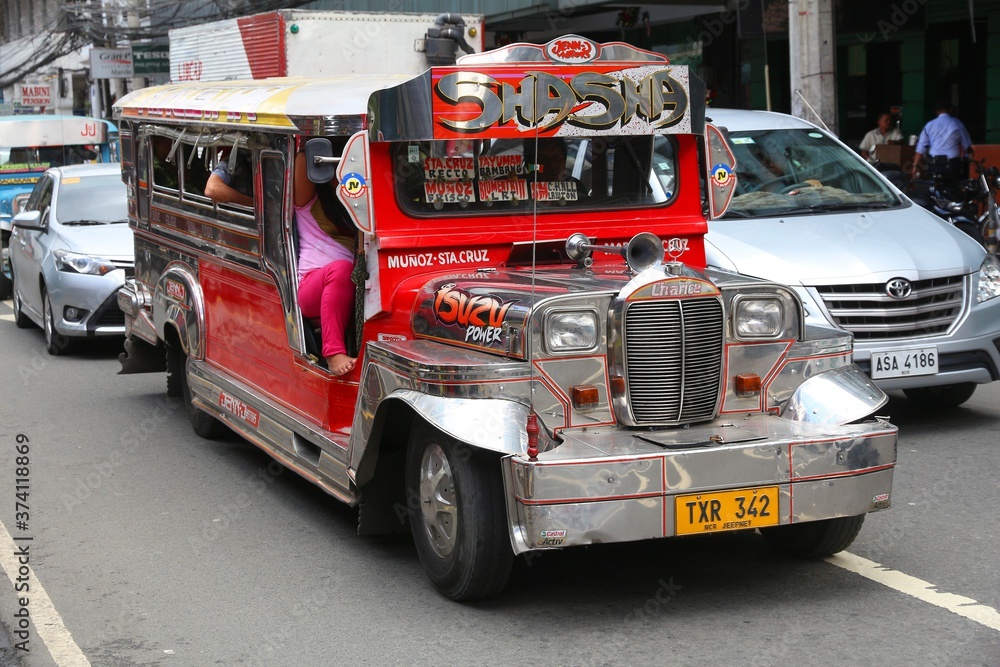 MANILA, PHILIPPINES - NOVEMBER 25, 2017: People ride a jeepney public ...