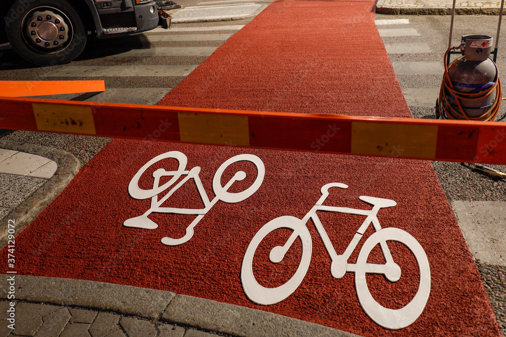 Stockholm, Sweden A road painting crew in Liljeholmen paint a bicycle ...