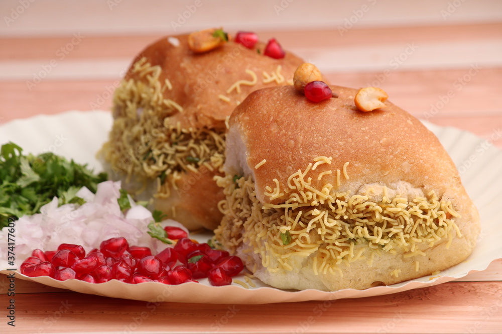 Dabeli is an Indian snack item served with Pomegranate Seeds and ...