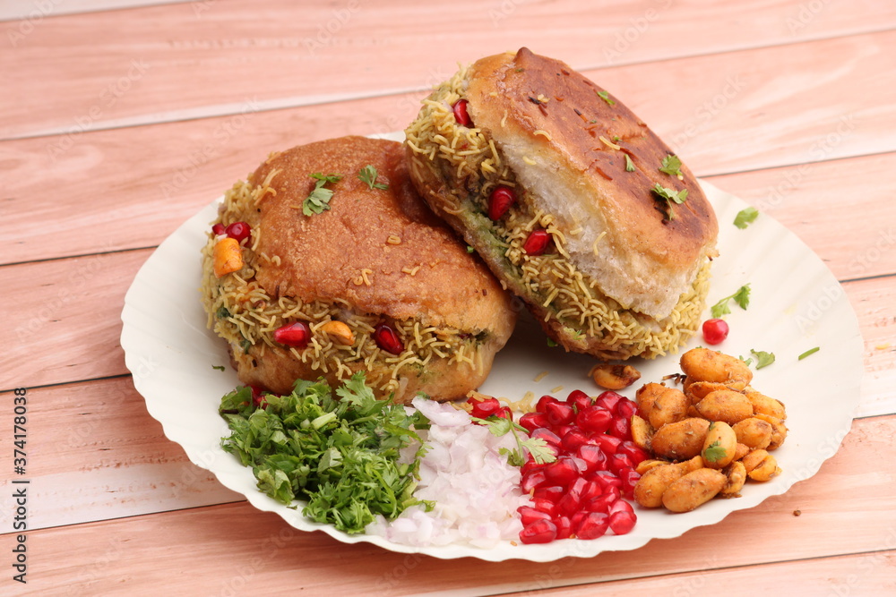 Dabeli is an Indian snack item served with Pomegranate Seeds and ...