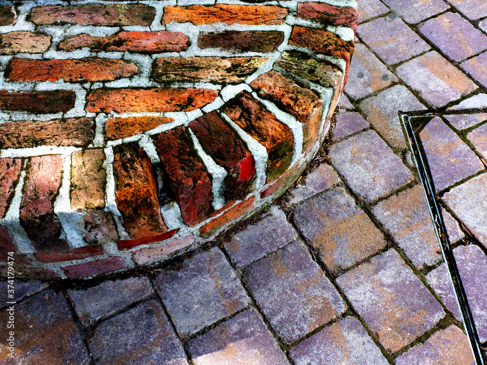 quater circle shaped red brick seat in public park. aged, deteriorating ...
