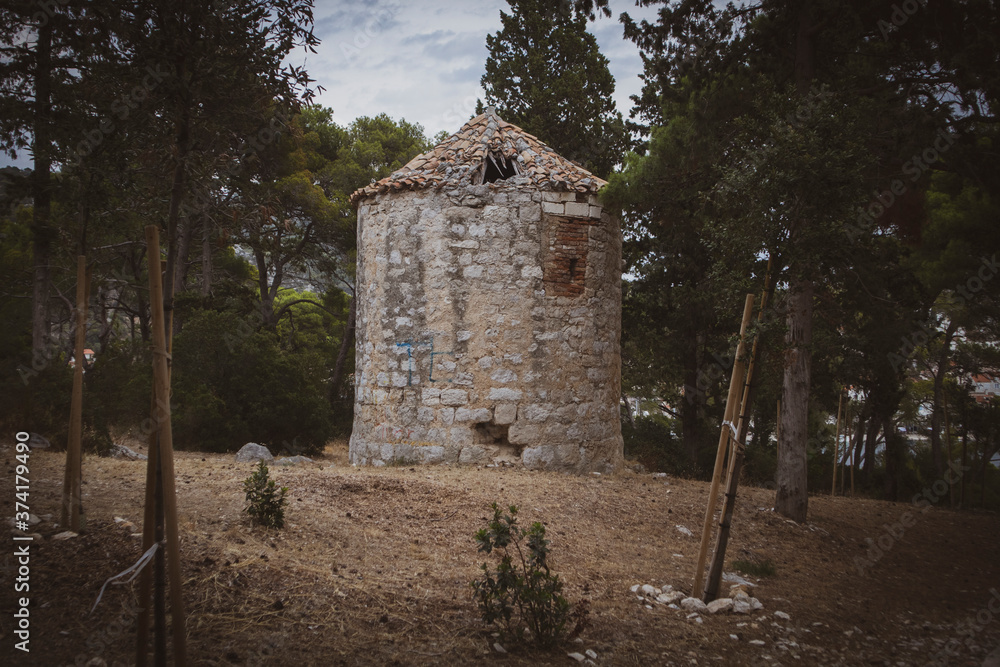 Old, historical, ruined small, stone defence tower with collapsed roof ...
