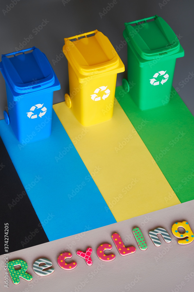 Three color coded recycle bins, isometric picture on geometric paper ...