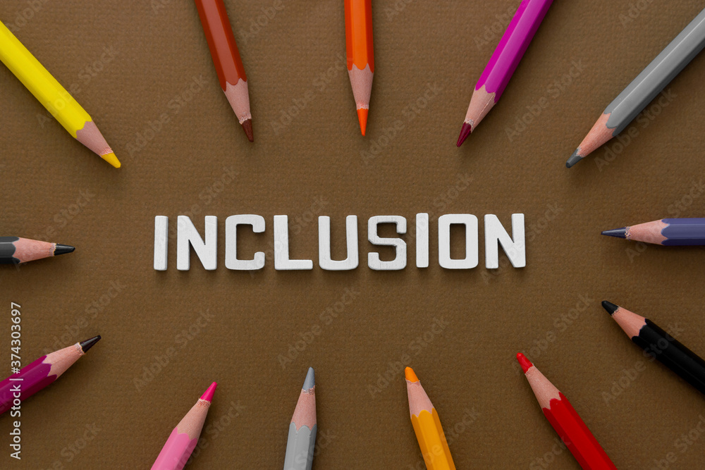 Inclusion word with colorful pencils over brown background. Equality ...