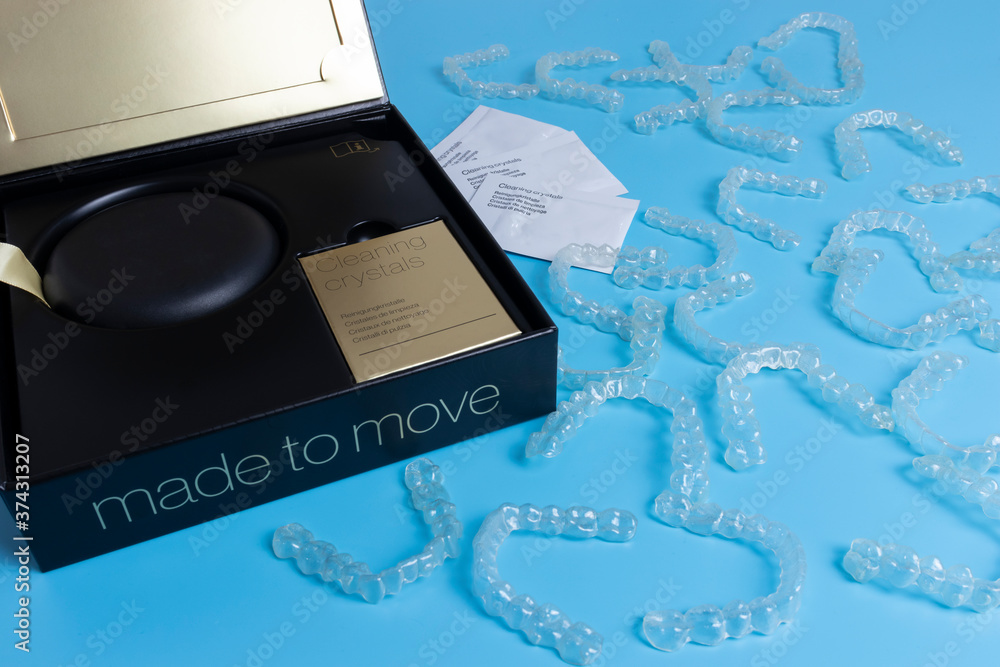 Invisible transparent braces or brackets package box on blue background ...
