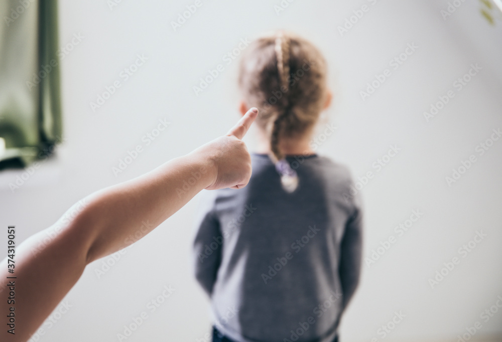 Child bully pointing finger at blurred unrecognizable victim and ...