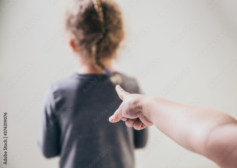 Child bully pointing finger at blurred unrecognizable victim and ...