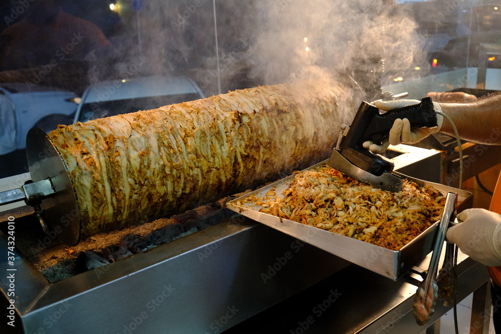 Preparation of chicken shawarma. chicken stack on slowly-turning ...
