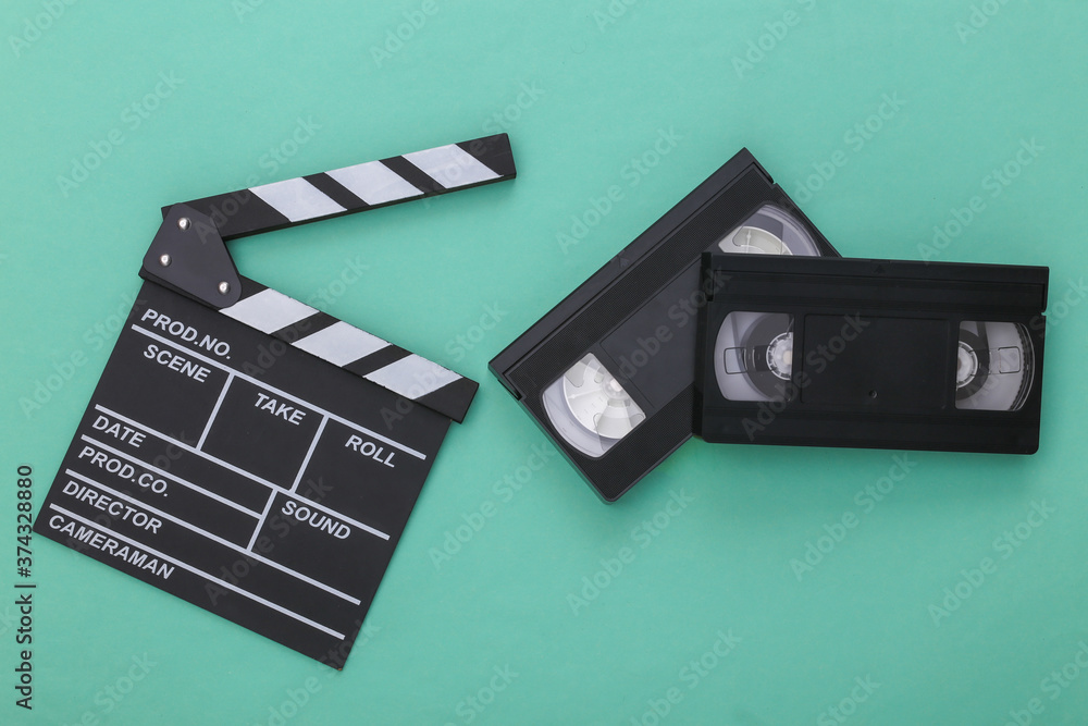 Retro Movie clapper board and video cassette on blue pastel background ...