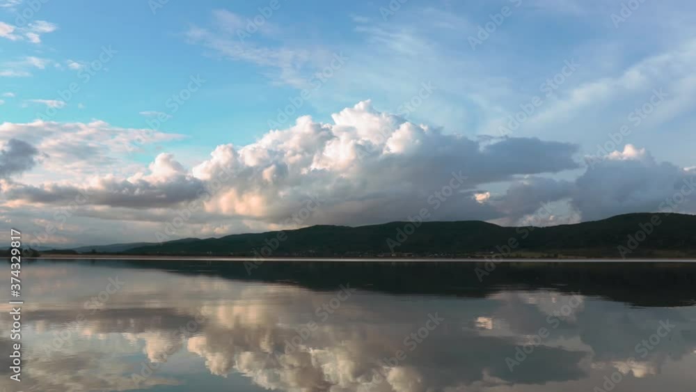 Clouds forming above the lake in summer time Stock Video | Adobe Stock