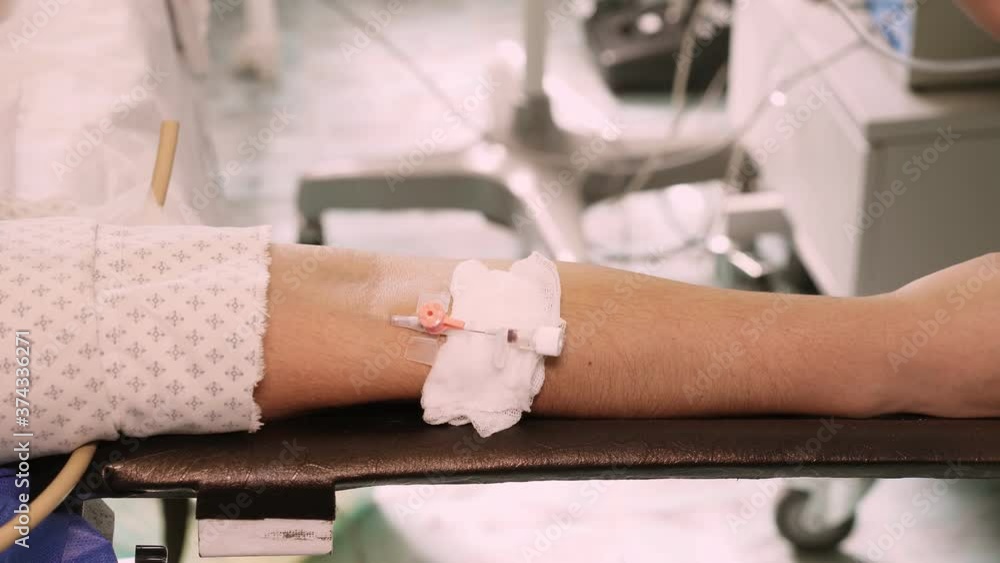 close-up. Peripheral venous catheter insertion in operation room ...