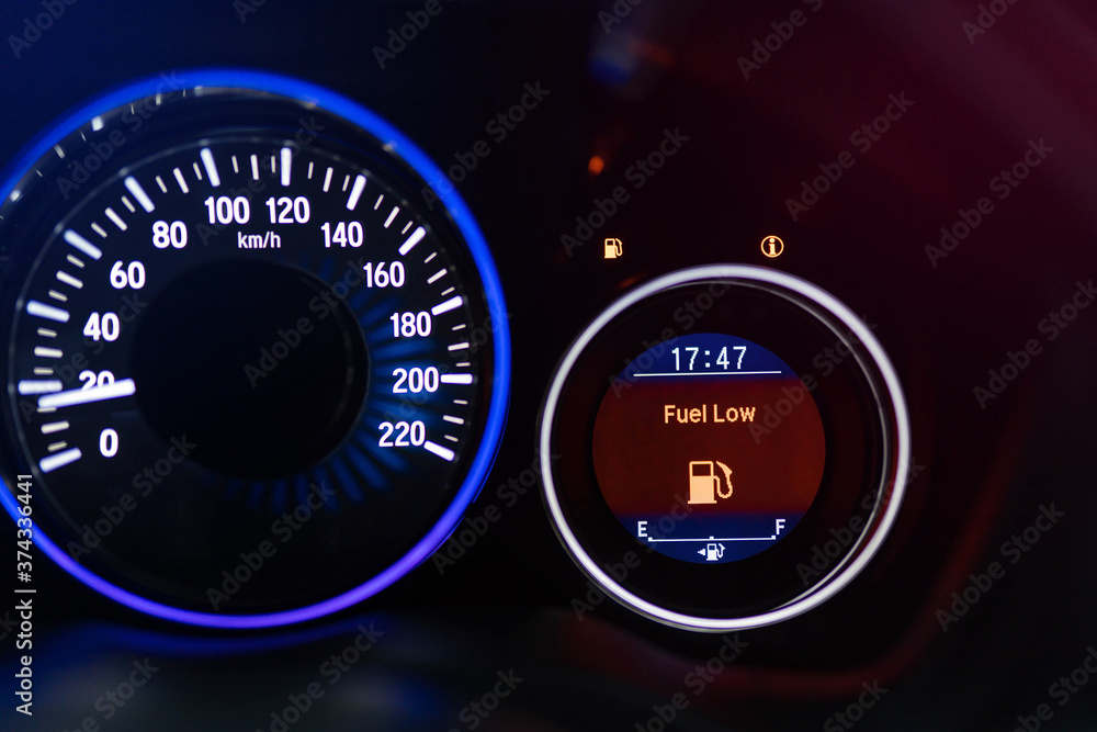 low fuel indicator light on the dashboard. Low fuel guage shown in a ...