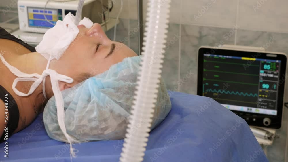close-up. female patient, in a state of anesthesia, lies on the ...