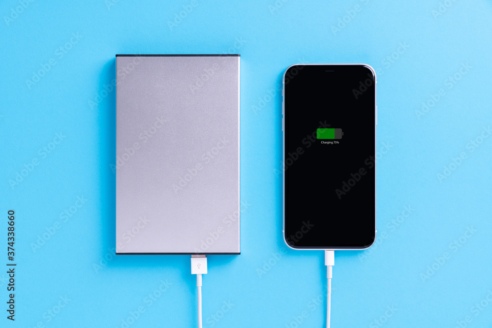 phone charging with external power supply on blue background Stock ...