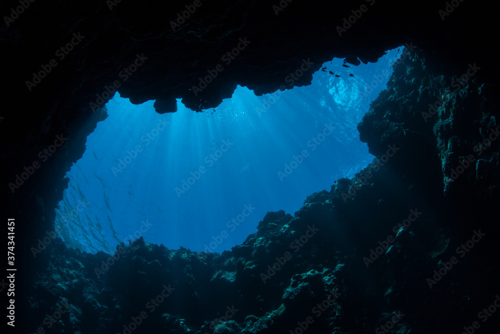 Foto de Sunlight filters into a dark, underwater cave in the Republic ...