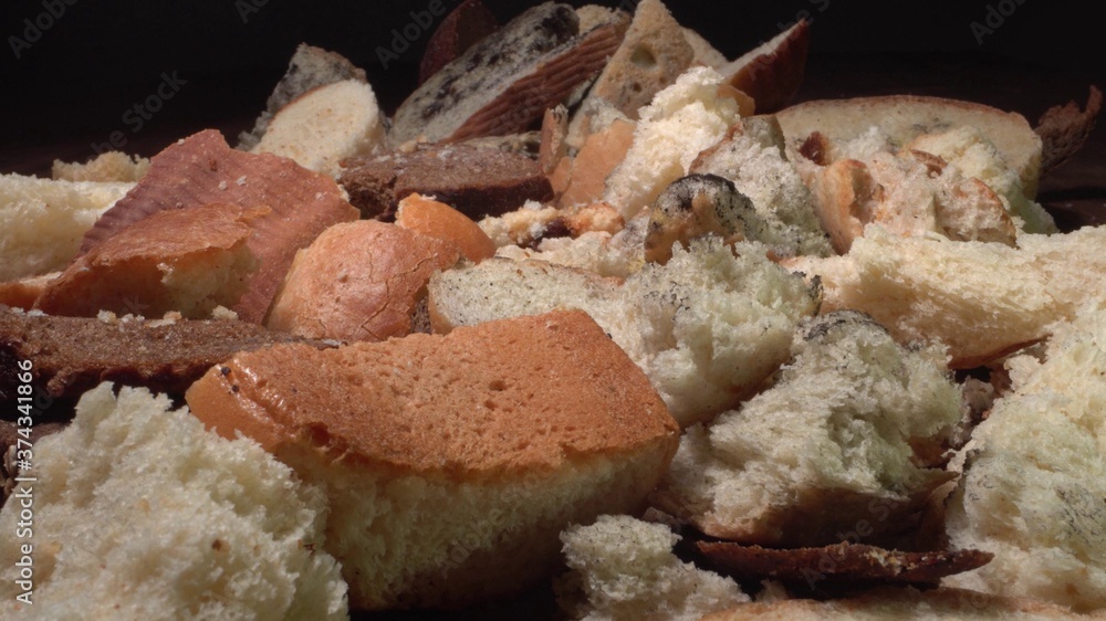 Food loss and waste. Wasted bread, food wasting. Discarded moldy bread ...