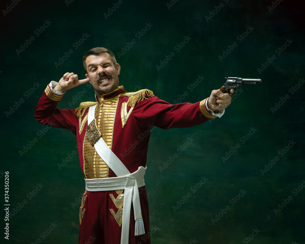 Shoting duelist. Young man in suit as Nicholas II isolated on dark ...