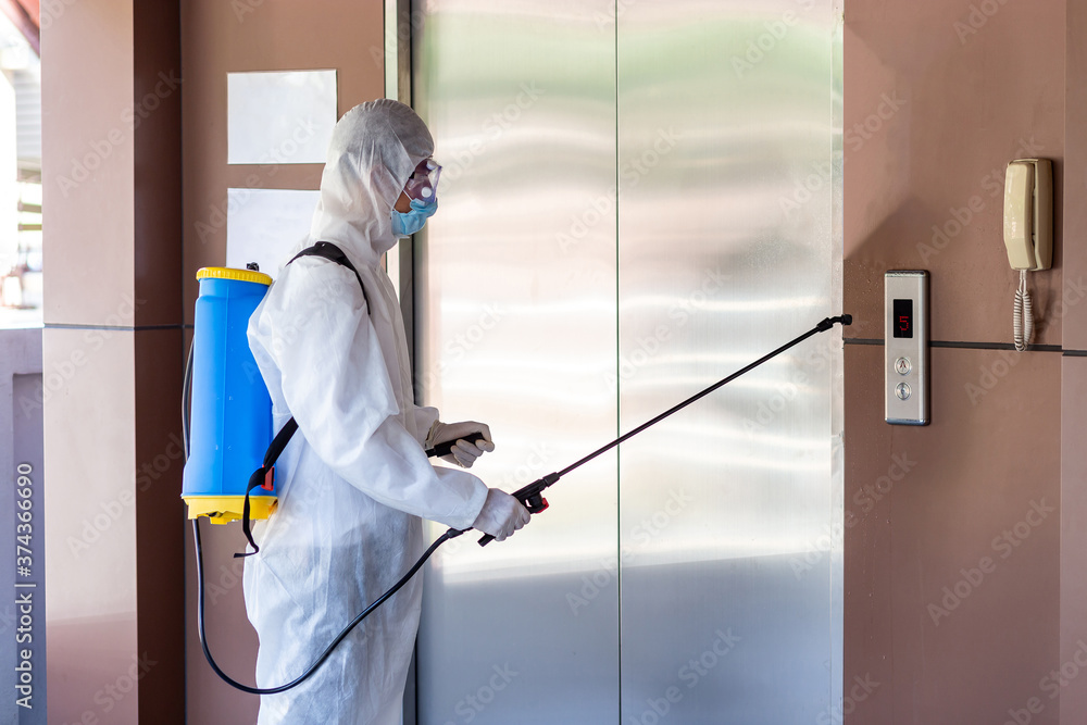 Male medical staff wearing PPE suits to protect against COVID-19 using ...