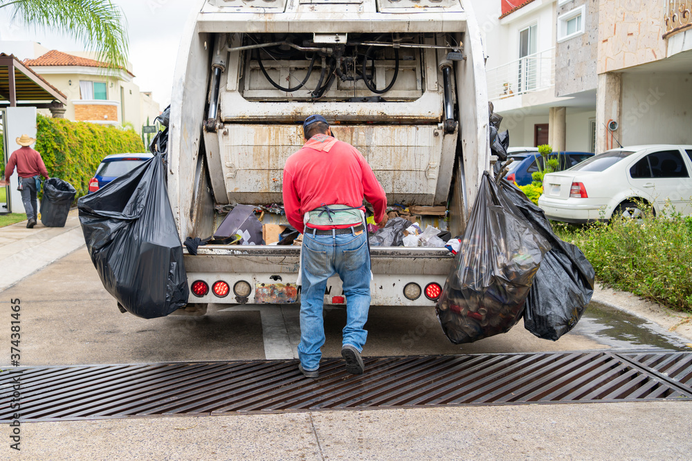 Foto de El trabajador de la basura está buscando residuos para reciclar ...