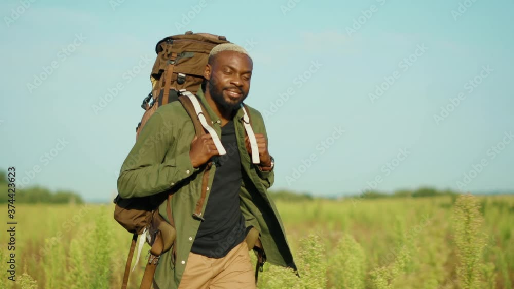 Esctatic afro-american traveler with large backpack traveling around ...