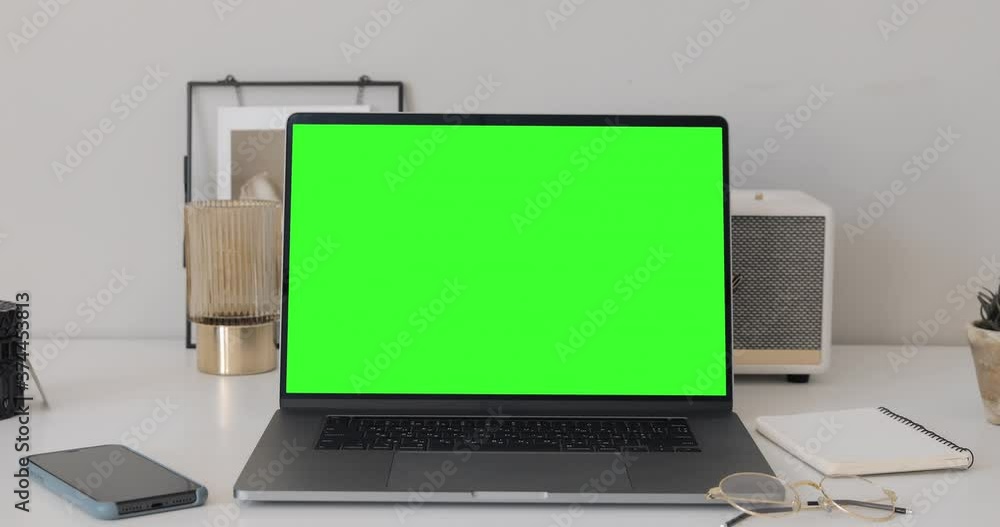 MacBook Pro laptop with mock up chroma key green screen on table of ...