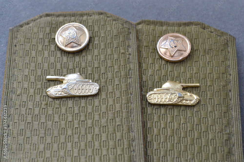 Button and emblem of tank troops on the shoulder straps of an ensign of ...