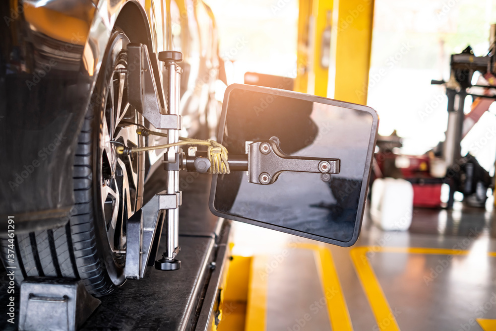 Foto de car automobile mechanic working on repairing the wheel tire of ...