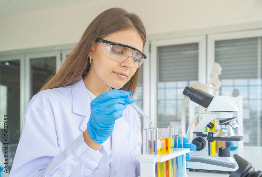 A western scientist woman working on test tube to analysis and develop ...