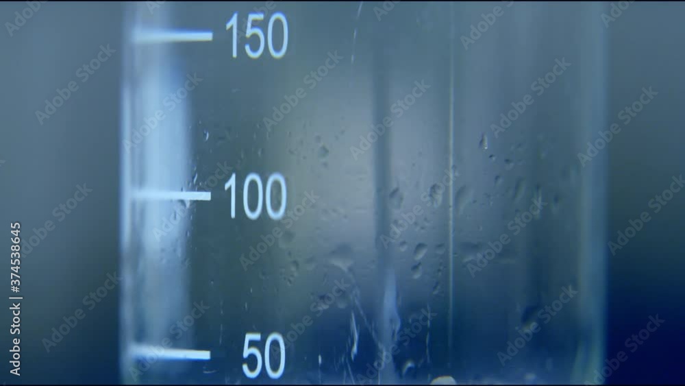 Professional scientific beaker tub glass with metric scale filling with ...