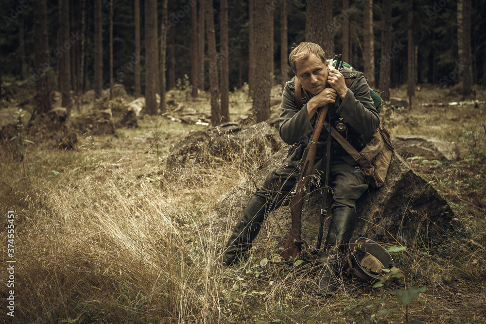 Tired soldier of the Finnish army during world war II, resting in the ...