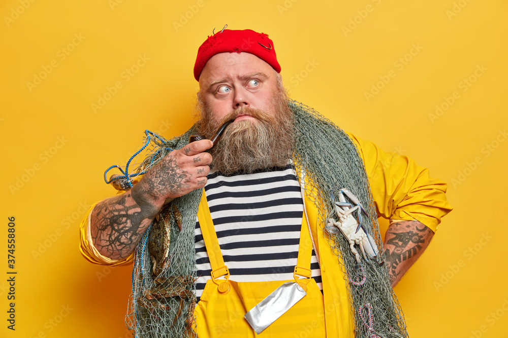 Old experienced bearded sailor thinks about next day at sea, poses with ...