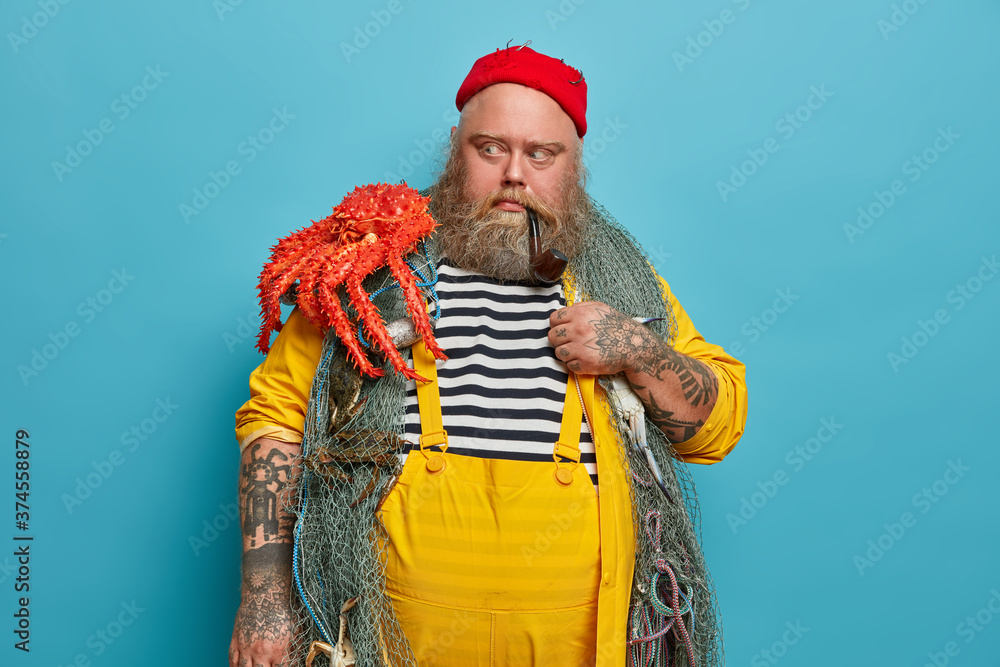 Male mariner looks with scared expression at octopus, afraids big sea ...