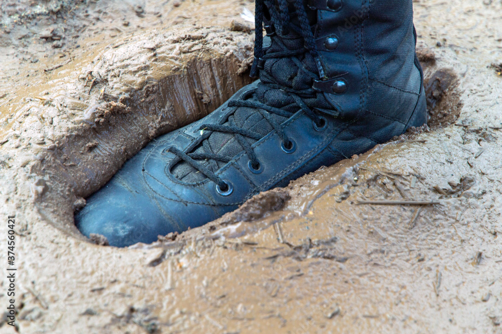 military boot stuck in wet and sticky mud Stock Photo | Adobe Stock