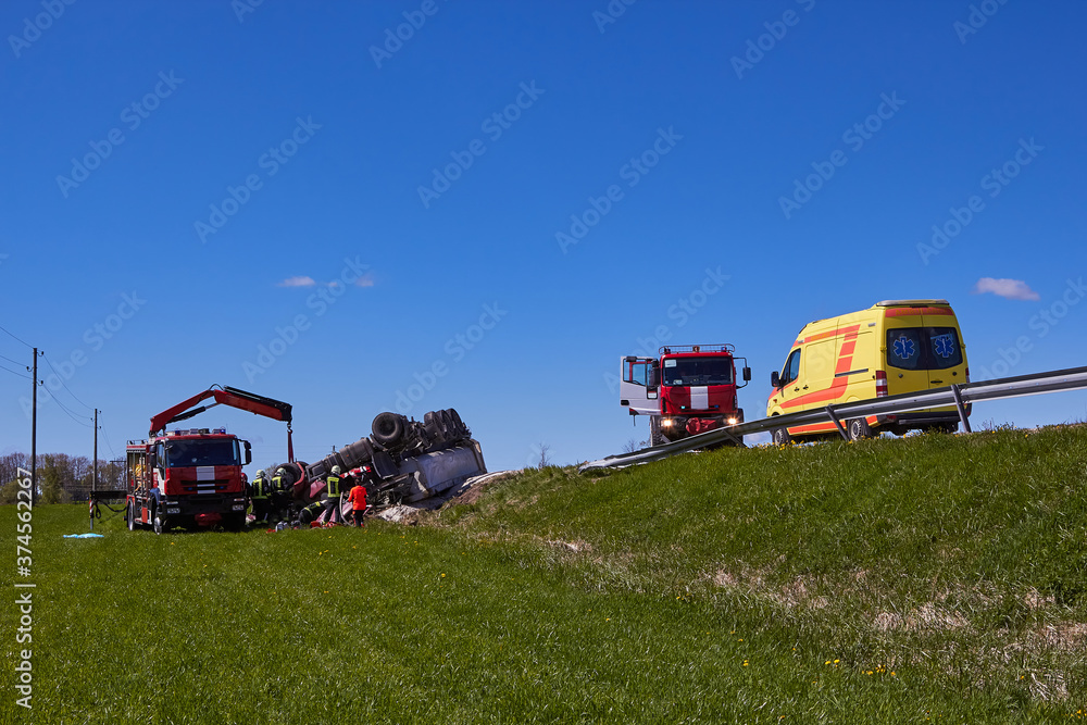 fire rescue service working on accident place where truck rolled over ...