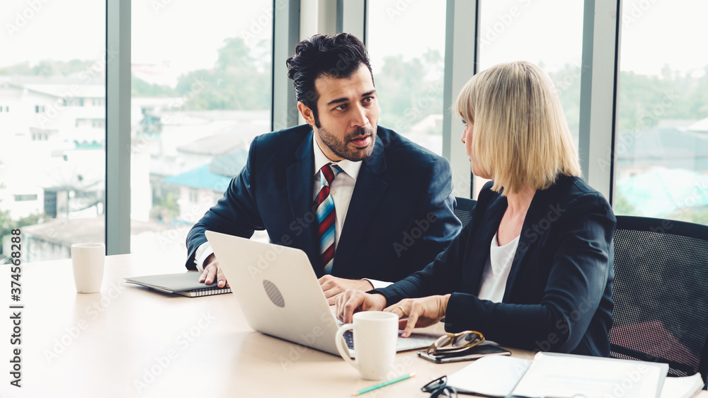 Two business people talk project strategy at office meeting room ...