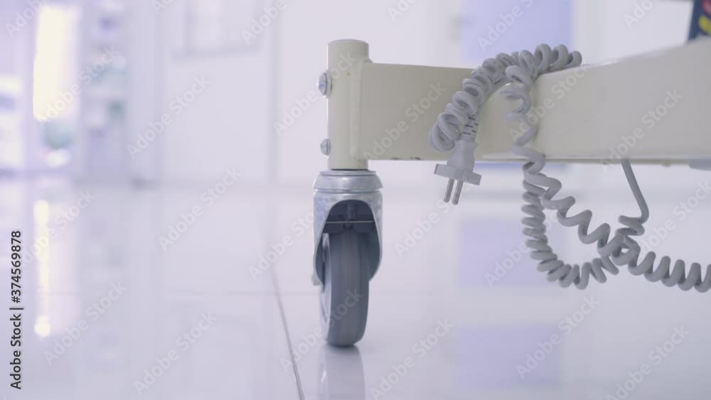 Wheel of mobile medical device moving to provide patient with emergency ...