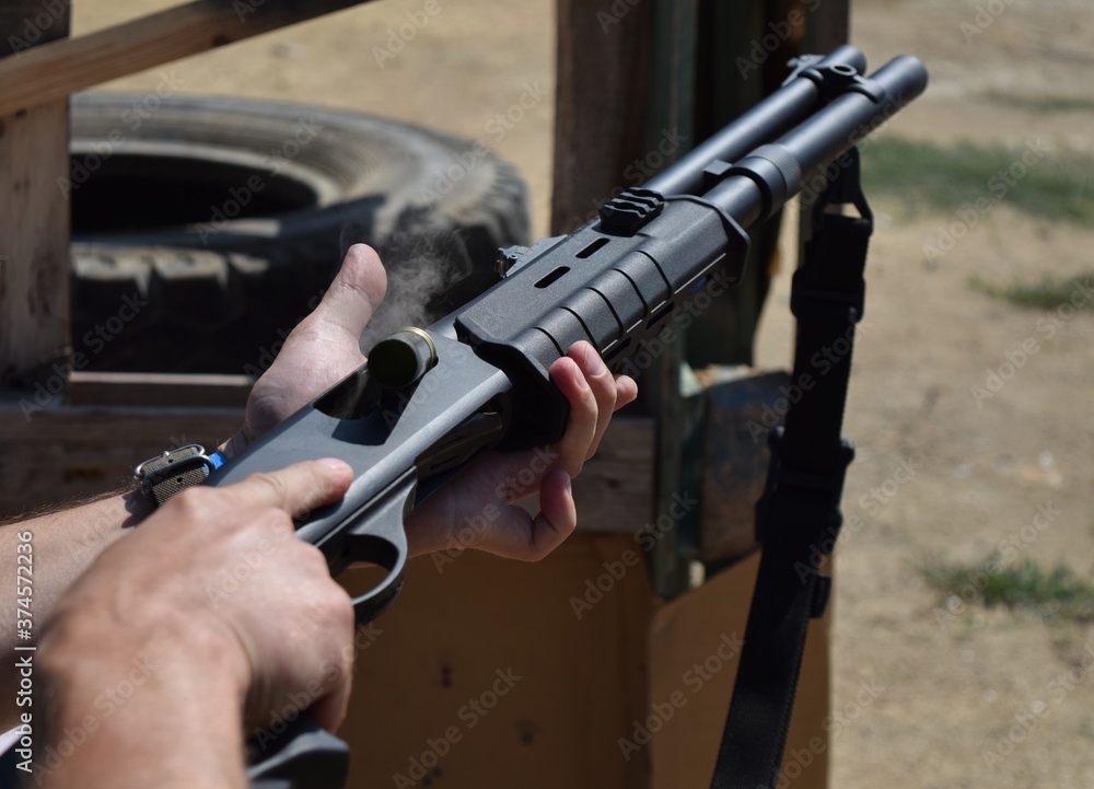 Pump-action shotgun ejects shotshell from ejection port Stock Photo ...
