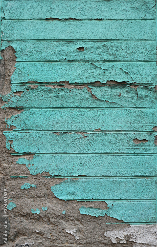 damaged turqouise blue wall with peeling paint and chipped over ...
