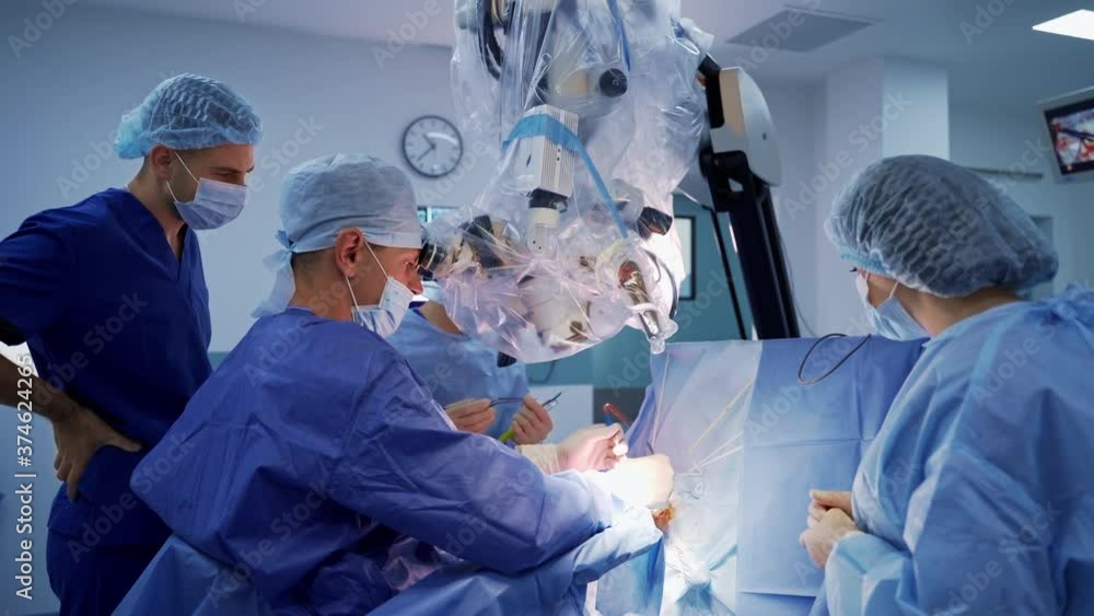 Professional neurosurgeon looks through the microscope. Medical ...