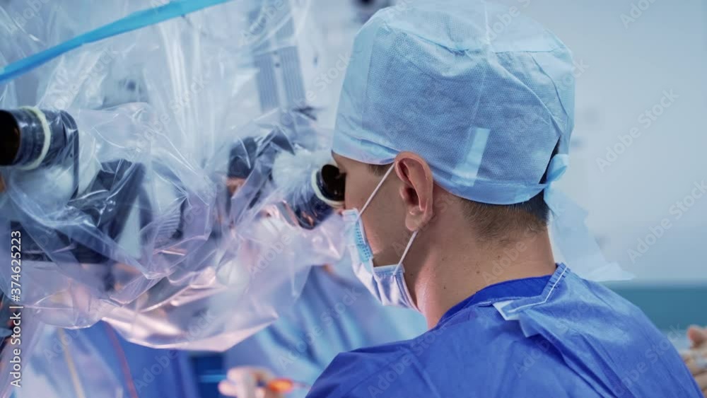 Doctor looks through the microscope. Professional neurosurgeon in ...