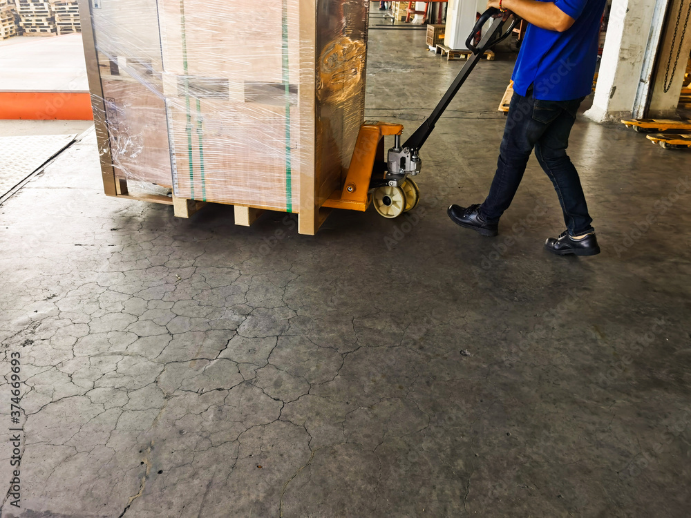 Worker driving forklift loading shipment carton boxes goods on wooden ...