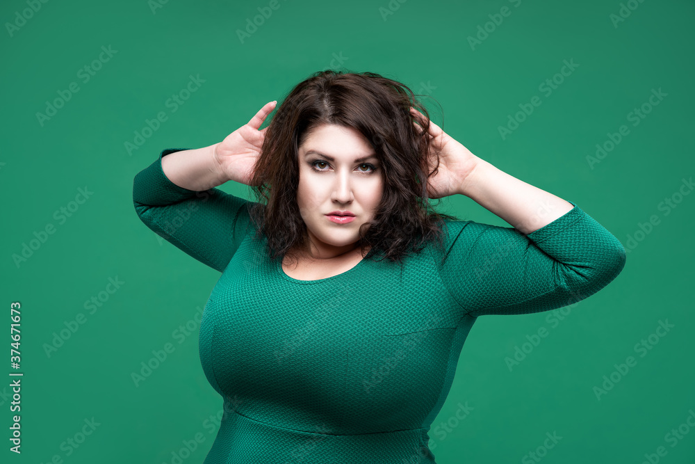 Plus size fashion model in green dress, fat woman on green background ...
