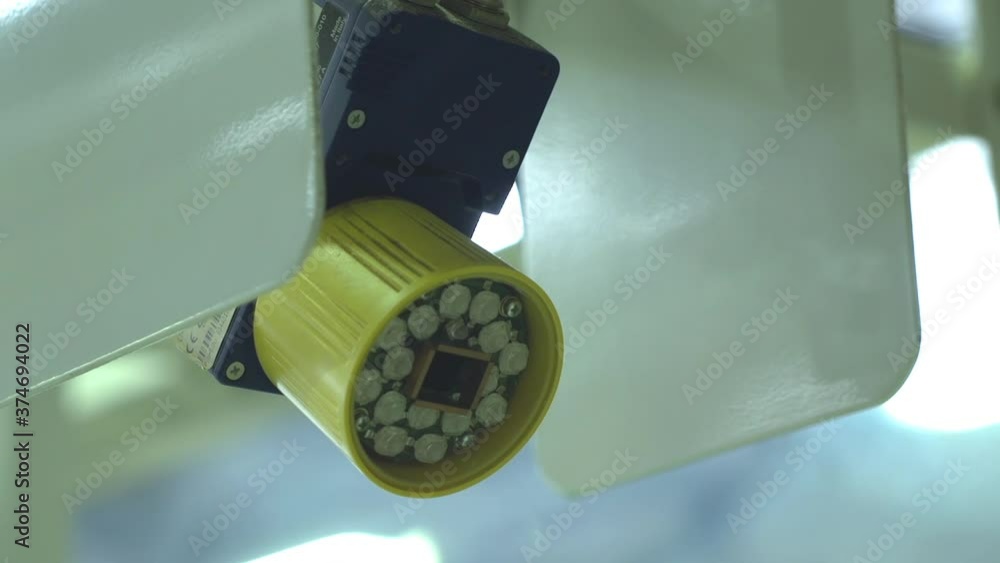 Automated barcode scanner flashes as it scans packages out for delivery ...