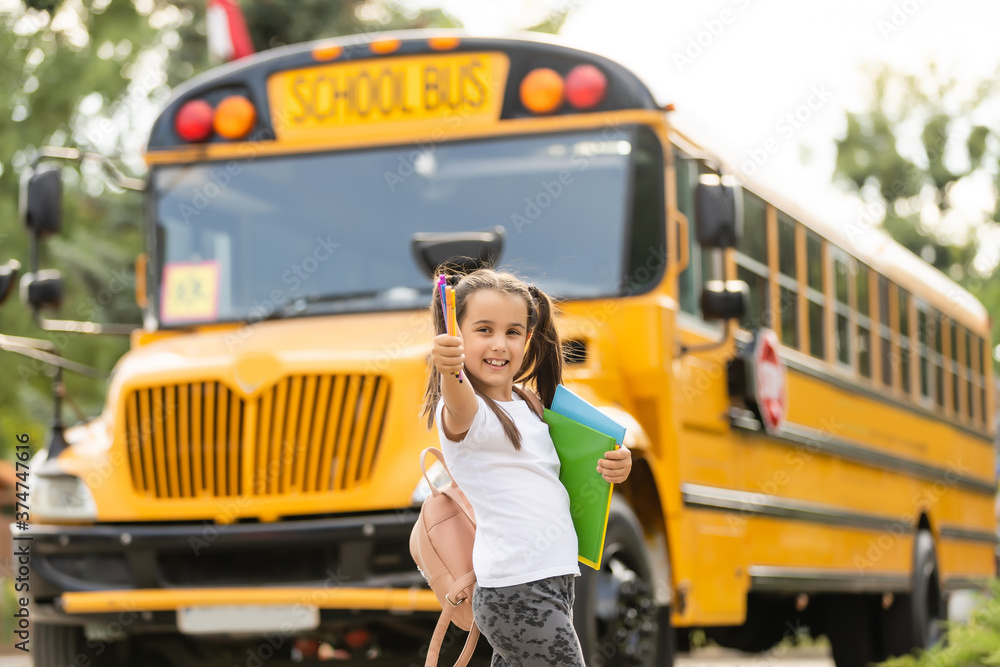Girl with backpack near yellow school bus. Transport for students Stock ...