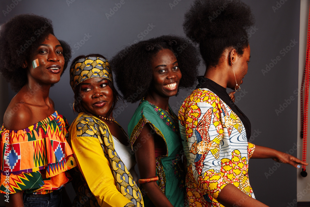 Four young beautiful African fashion models have fun and laughing in ...