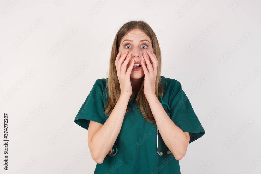 Stupefied Female doctor wearing a green scrubs and stethoscope ...