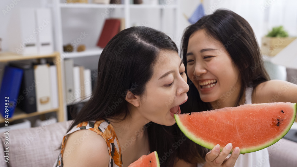 Happy female friends eating watermelon home party taking selfie sharing ...