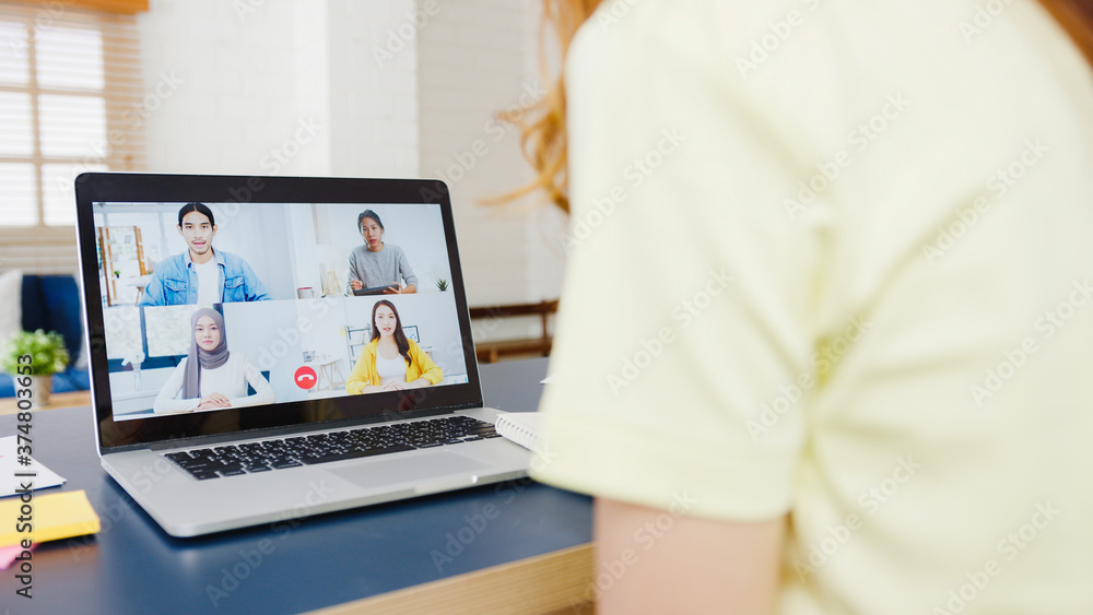 Asia businesswoman using laptop talk to colleagues about plan in video ...