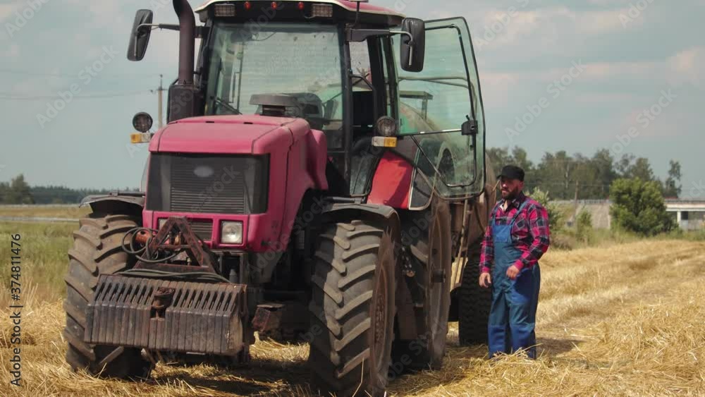 Vídeo do Stock: Brutal bearded farmer in a work uniform near a modern ...